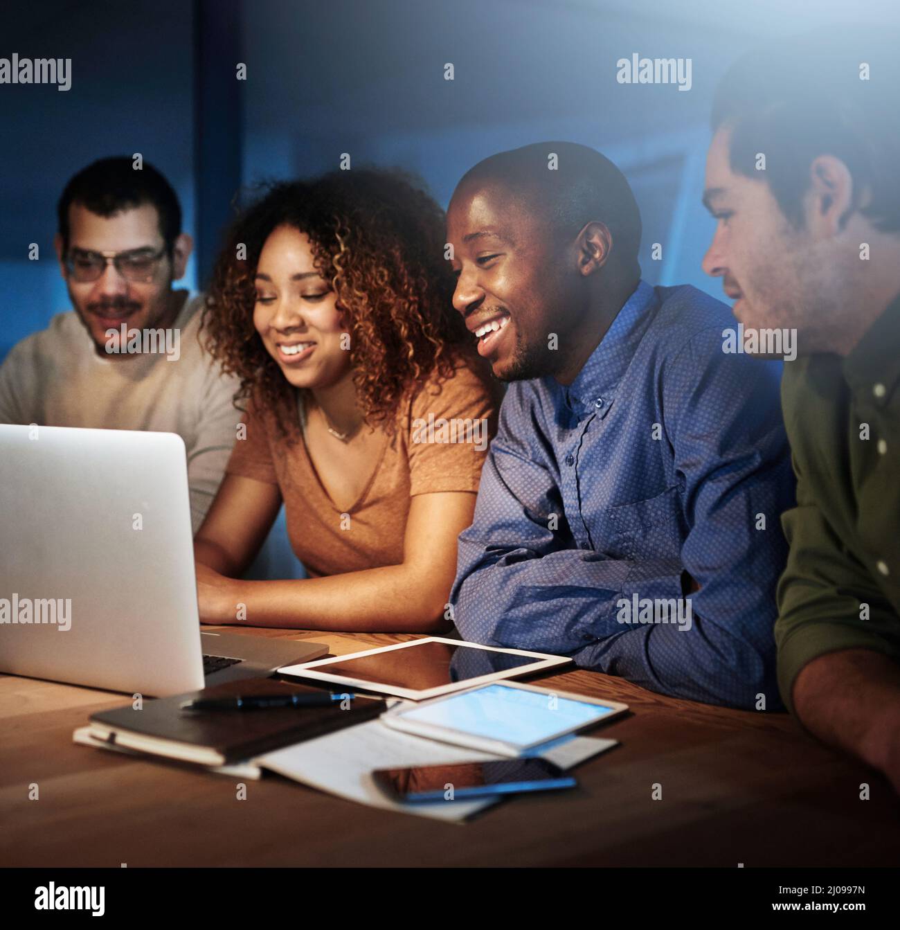 Total career commitment. Shot of a team of young businesspeople working ...