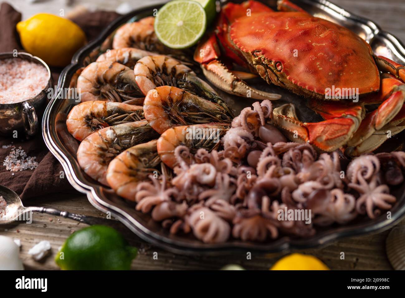 Close-up view of dish with assorted seafood served with spices on ...