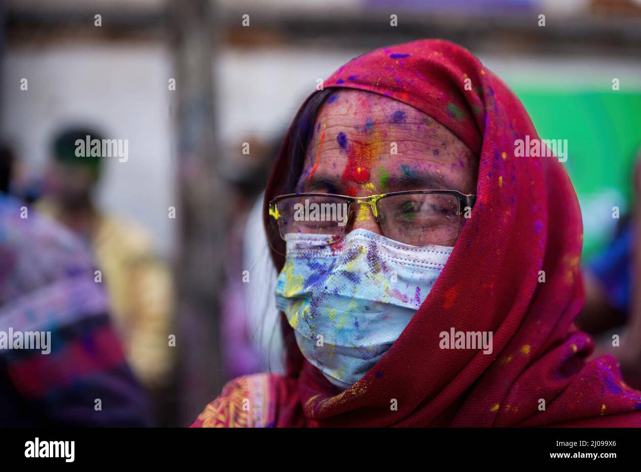 A woman's face smeared with vermilion powder seen during the festival ...