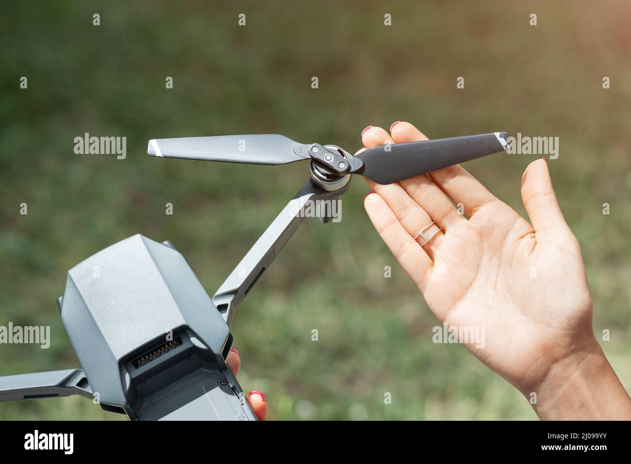 The hand holds the blade of the drone's propeller. Technical nuances of ...