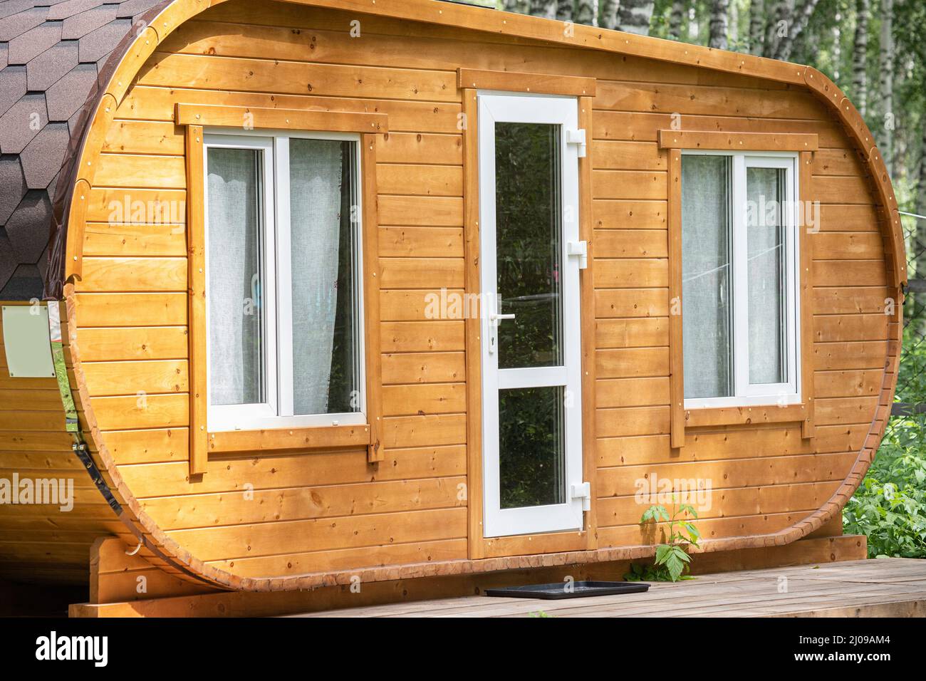 Wooden summer house or mobile cabin in the camp site. Living in nature ...