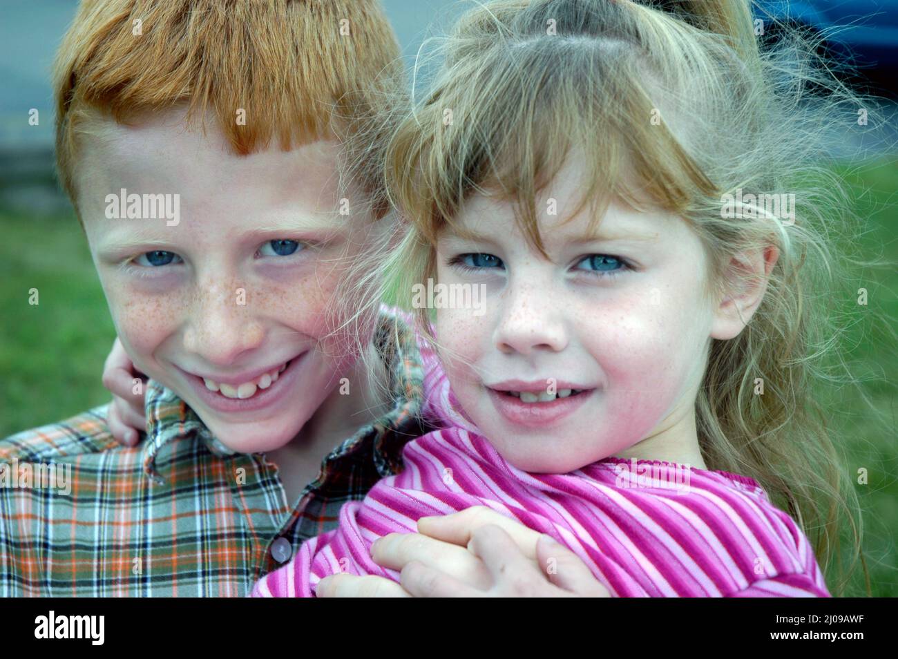 Kids in same family playing together at family gathering Stock Photo ...