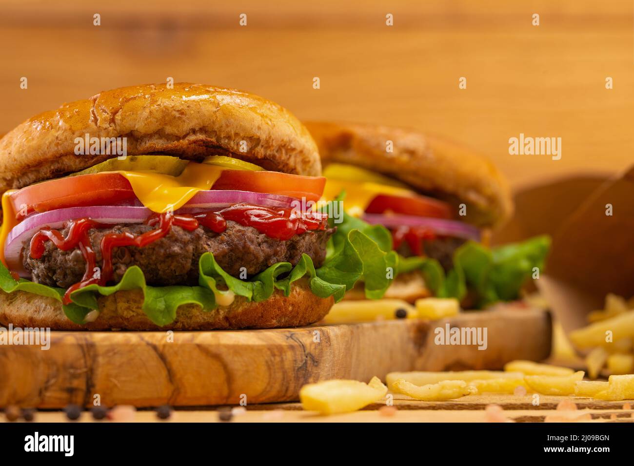 Appetizing burgers with beef, tomato, lettuce, red onion, cheese ...