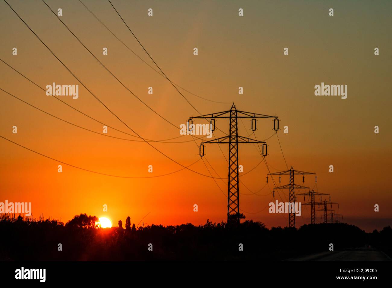 Electric power pylon, electric tower at sunset Stock Photo - Alamy