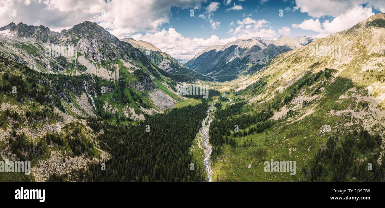 Aerial view of a vast river valley in the mountains overgrown with ...