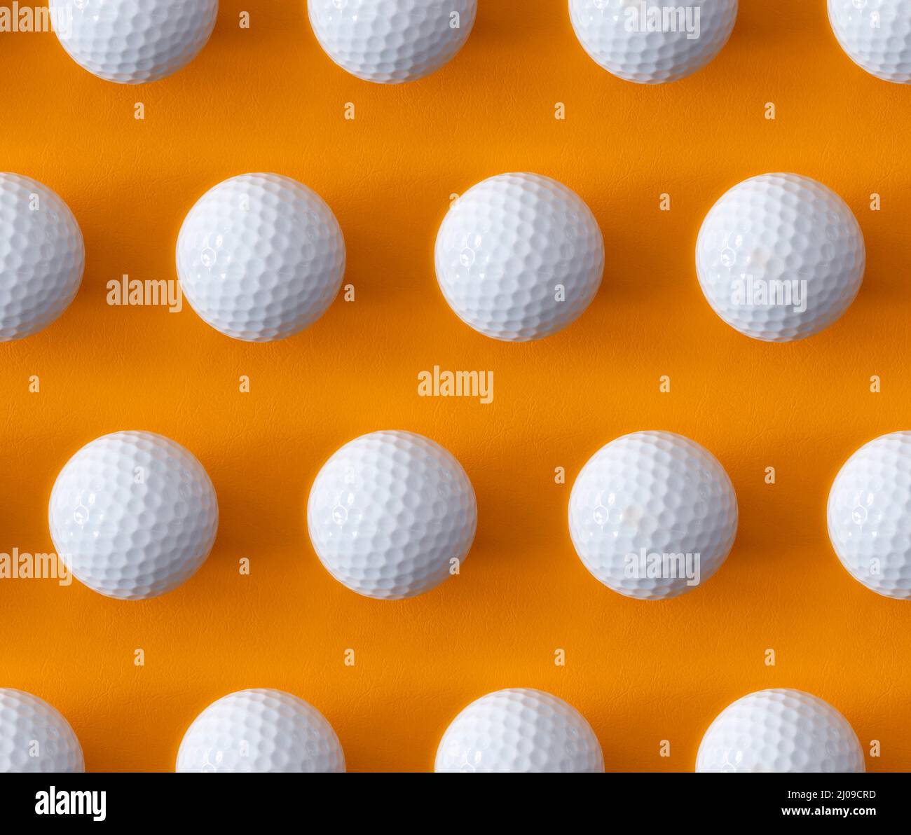 Golf ball pattern on a orange background Stock Photo - Alamy