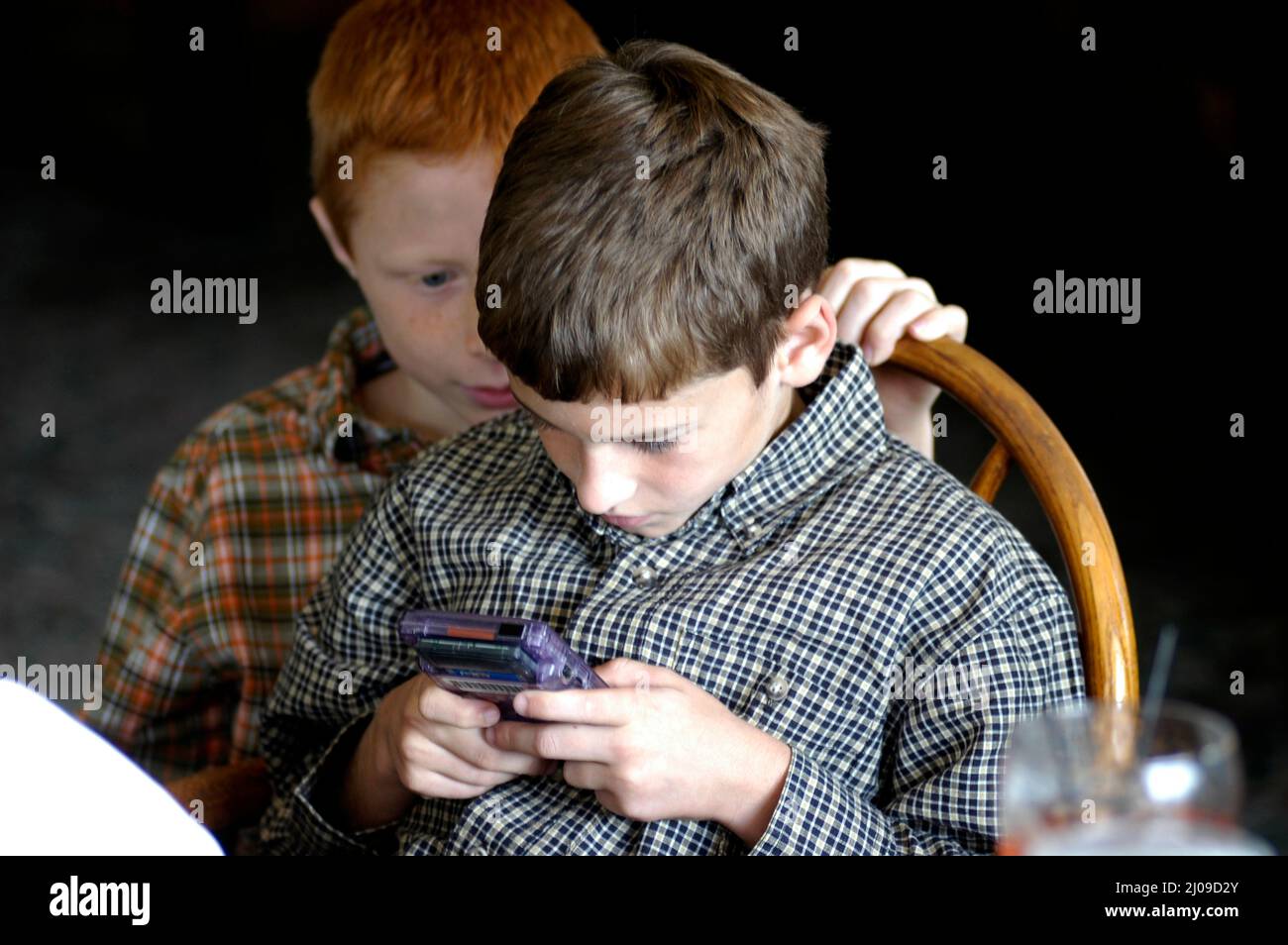 Kids face in same family playing computer games together at family ...
