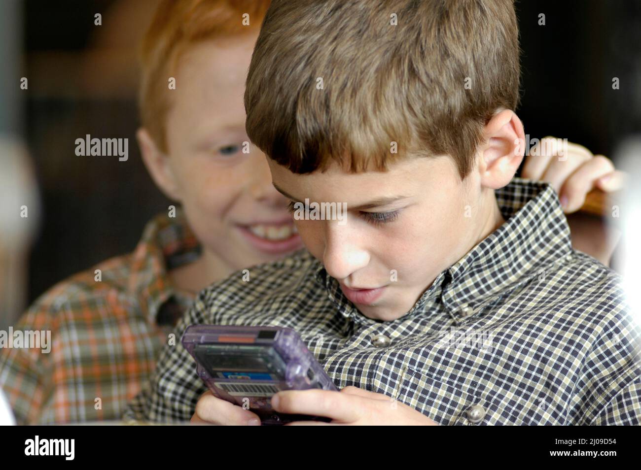 Kids face in same family playing computer games together at family ...