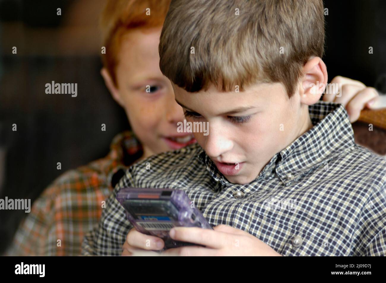 Kids face in same family playing computer games together at family ...