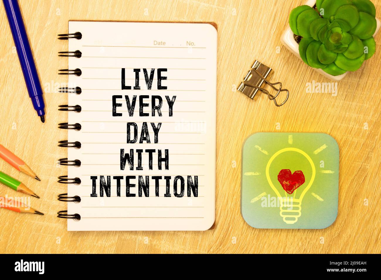 Live every day with intention. Words written under torn paper ...