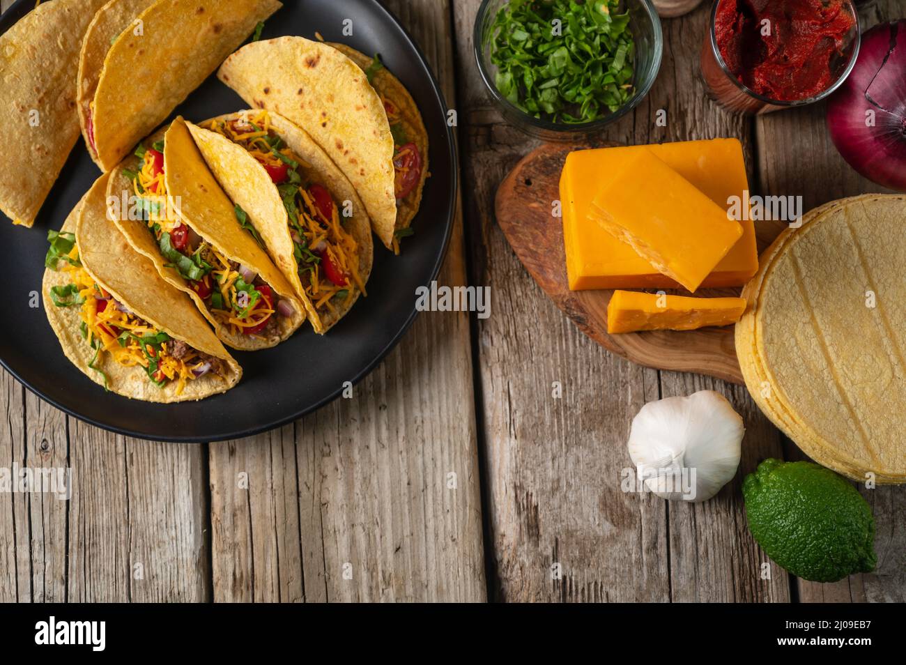 Top view of plate with tasty mexican tacos on rustic wooden table with ...