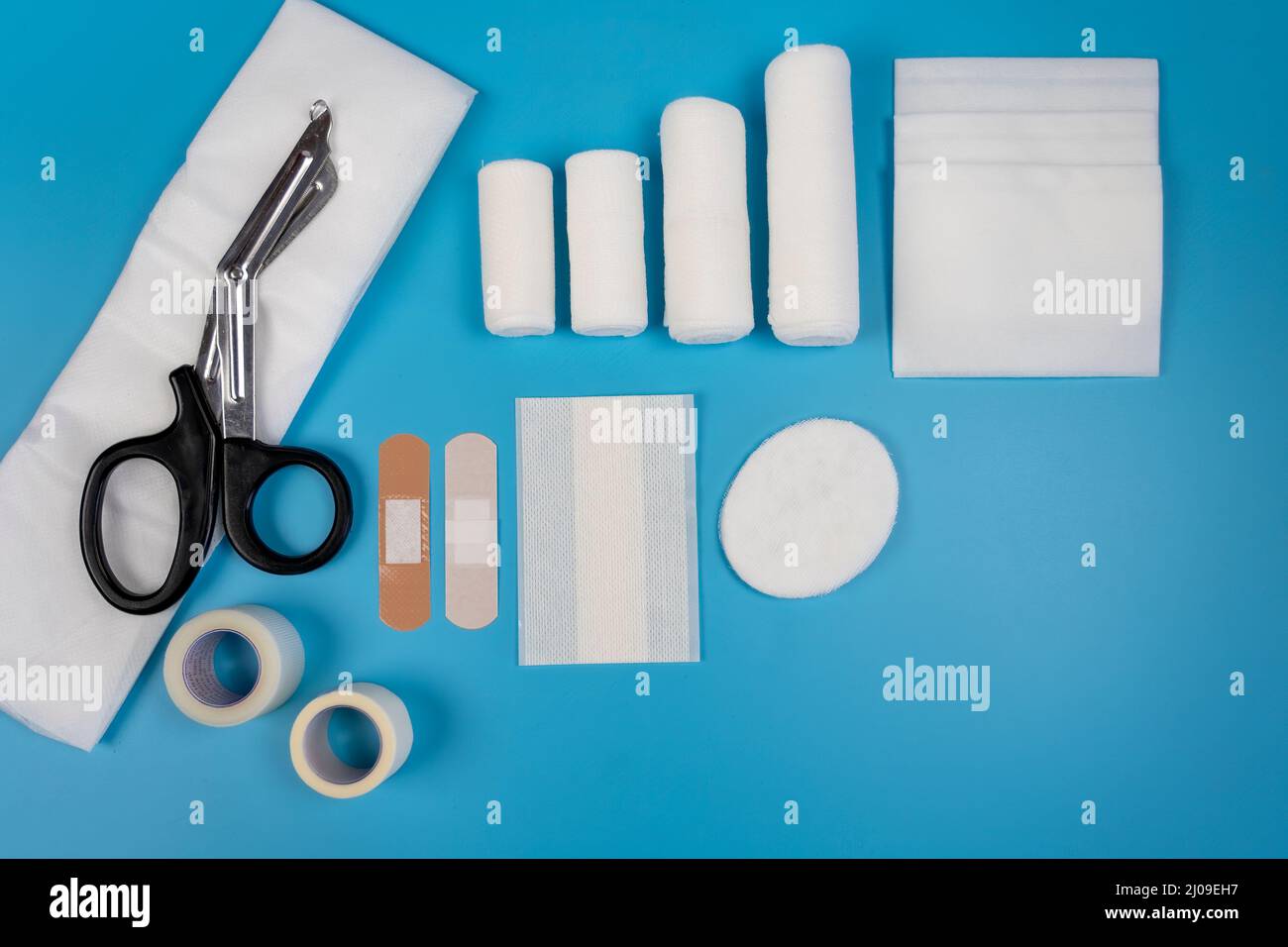 First aid kit against blue colored surface Stock Photo - Alamy