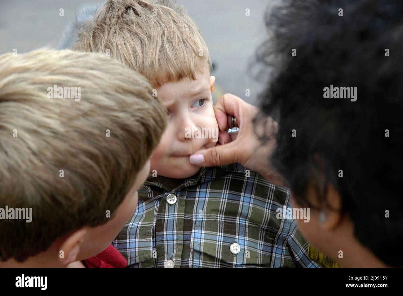Kid at family gathering playing with other family members Stock Photo ...