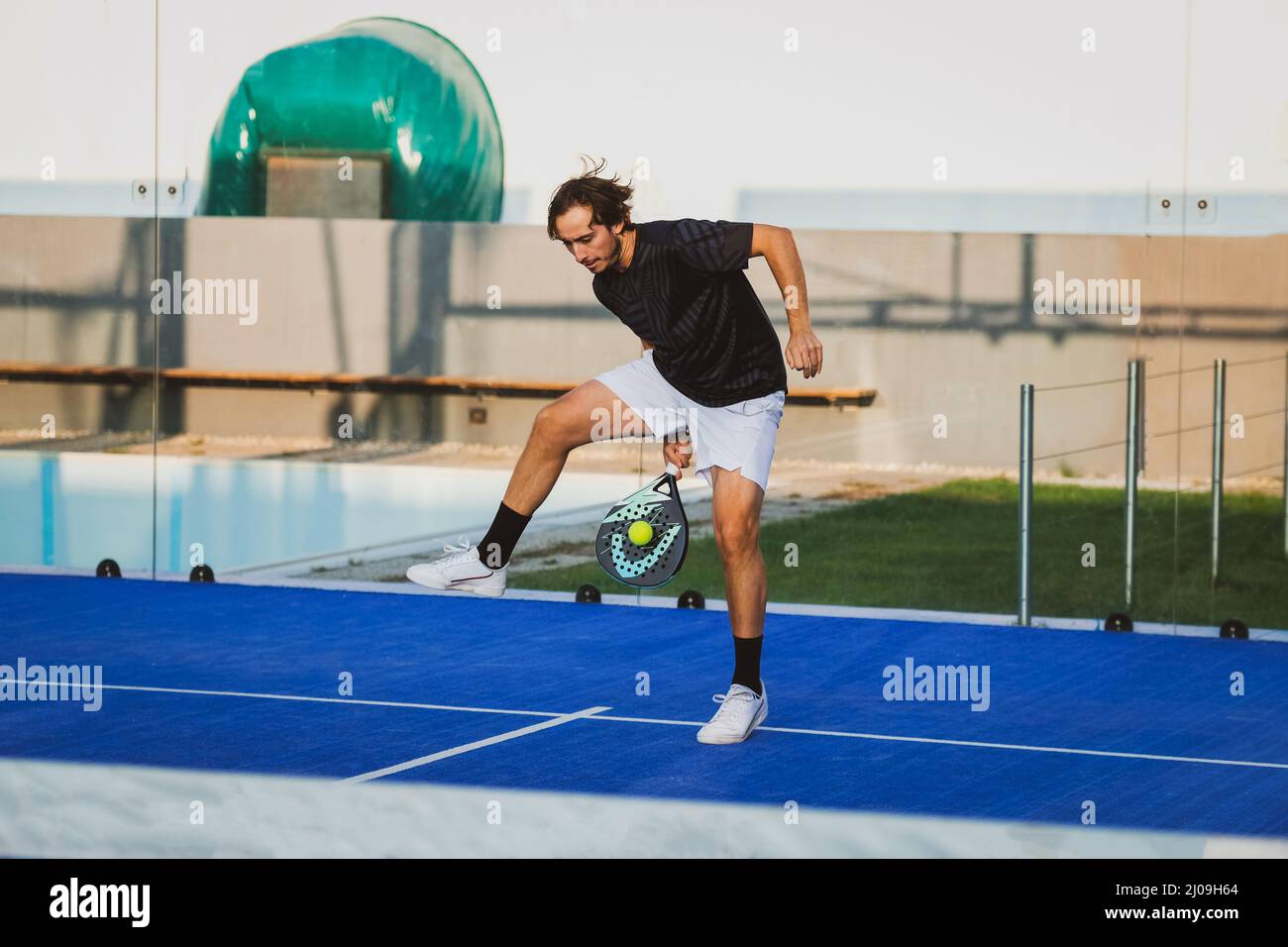Padel match in a blue grass padel court - Padel player playing a match ...