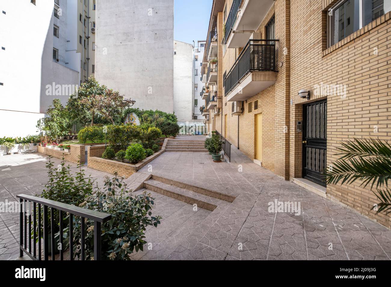 Inner courtyard of common areas of urban residential homes with gardens ...