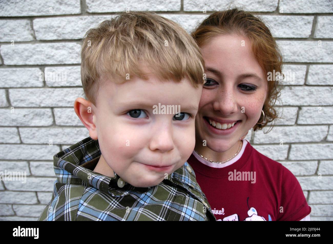 Kids at family gathering - Older sister and youngest brother who are ...