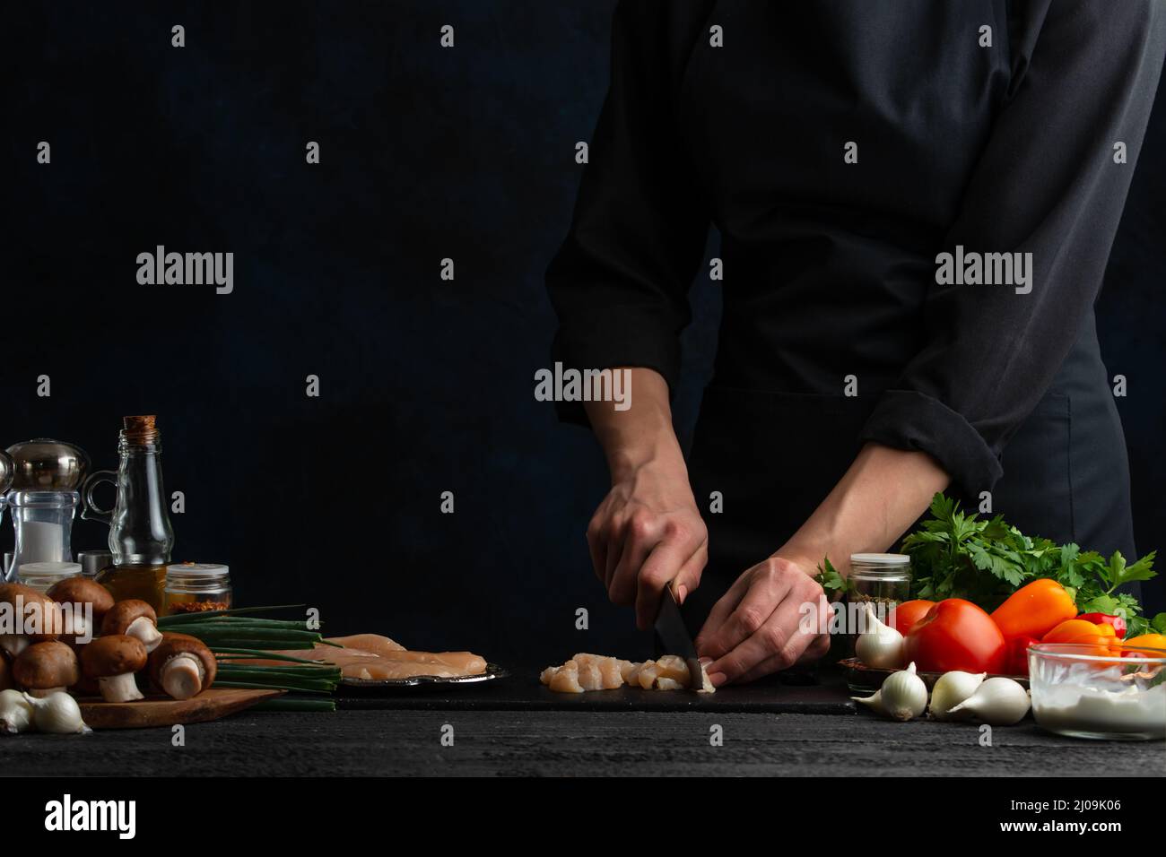 Female chef cuts raw chicken hi-res stock photography and images - Alamy