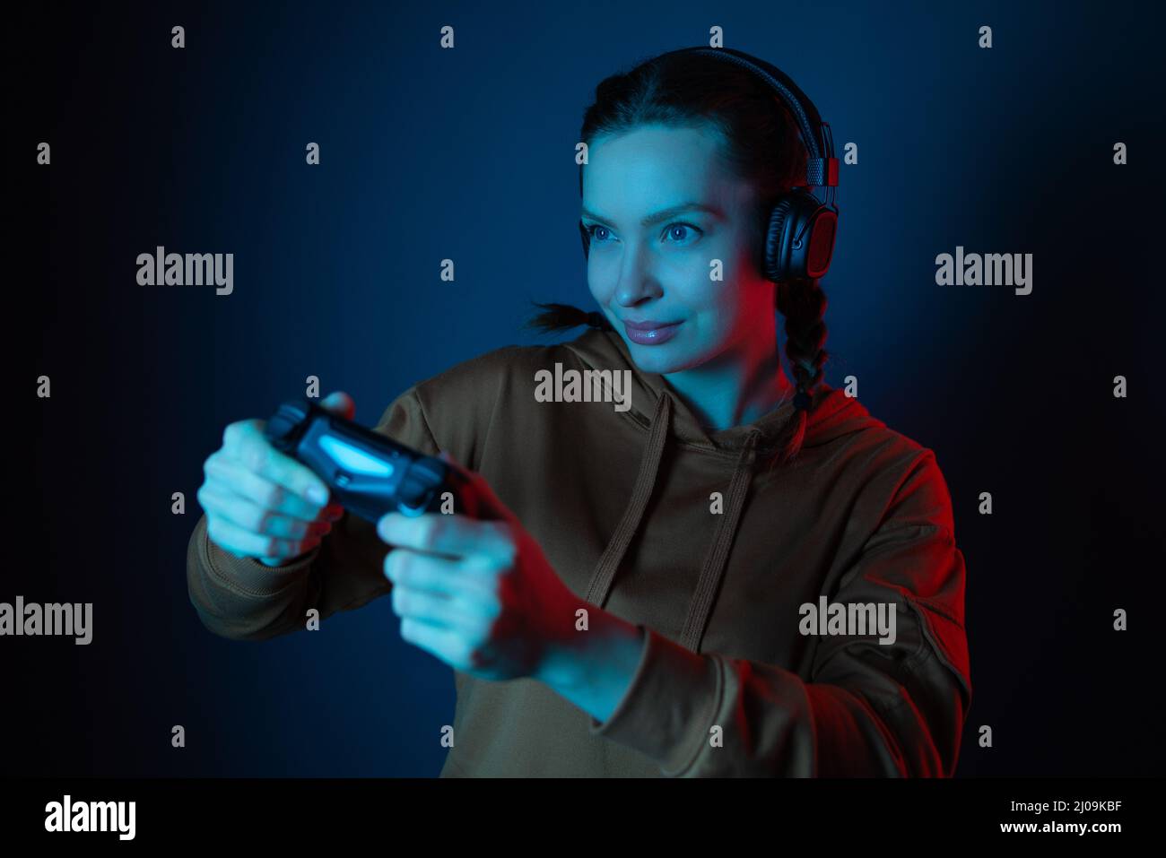 Gambling emotional woman playing online video game with headphone and ...