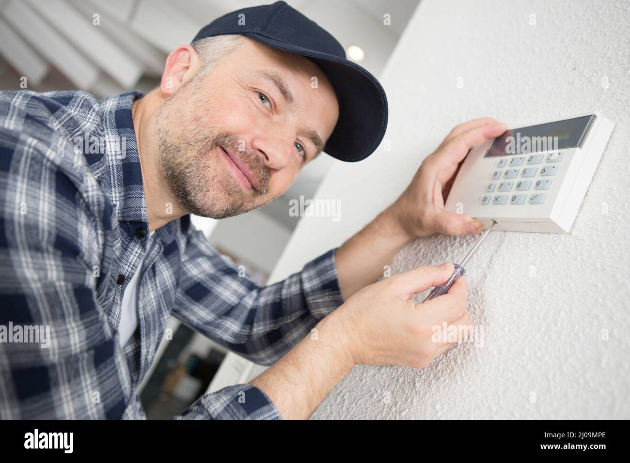 a person adjusting thermostat control Stock Photo - Alamy