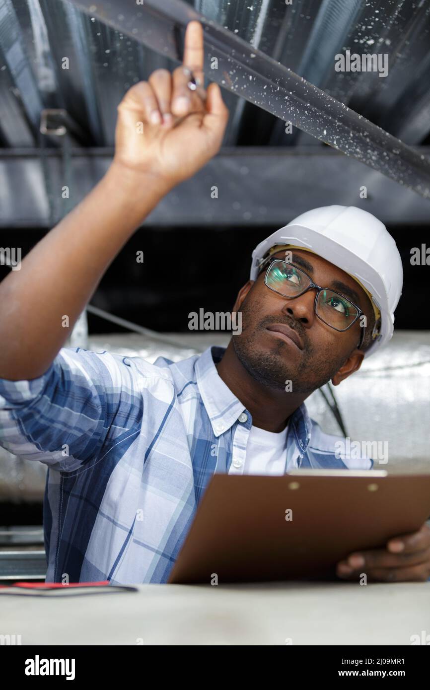 male builder pointing at ceiling Stock Photo - Alamy