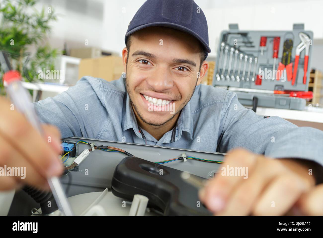 happy worker fixing a machine Stock Photo - Alamy