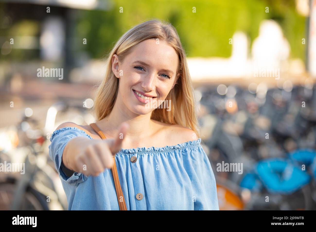 confident woman taking bike via bike renting services Stock Photo - Alamy