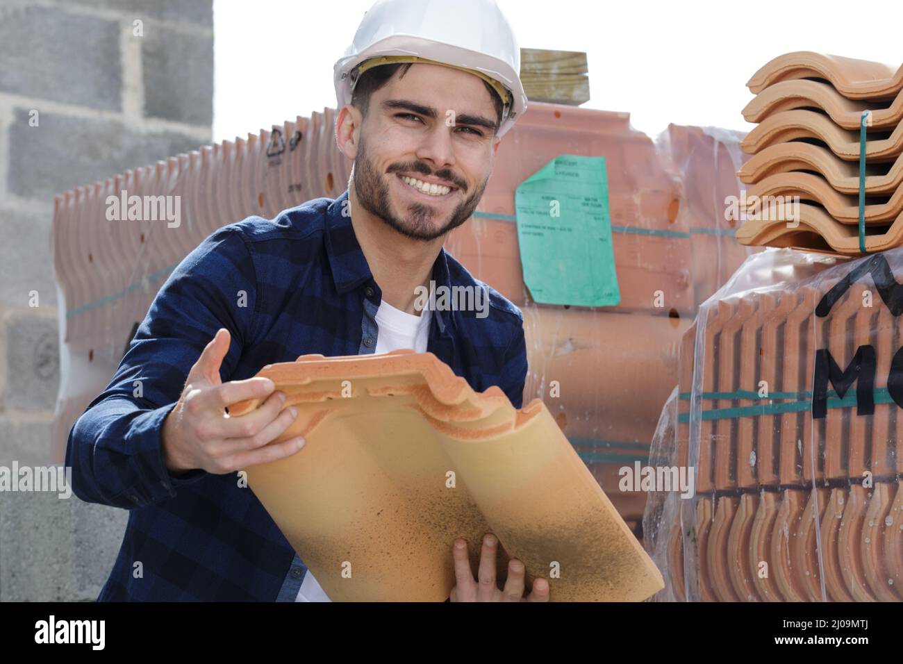 builder shifting tiles for house renovation Stock Photo - Alamy