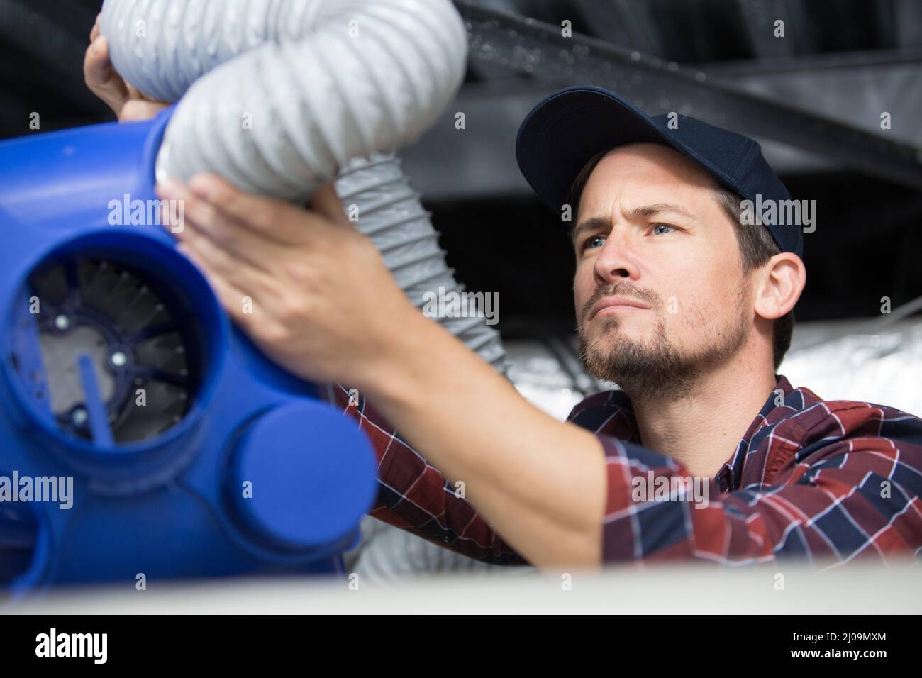 male ventilation installer at work Stock Photo - Alamy