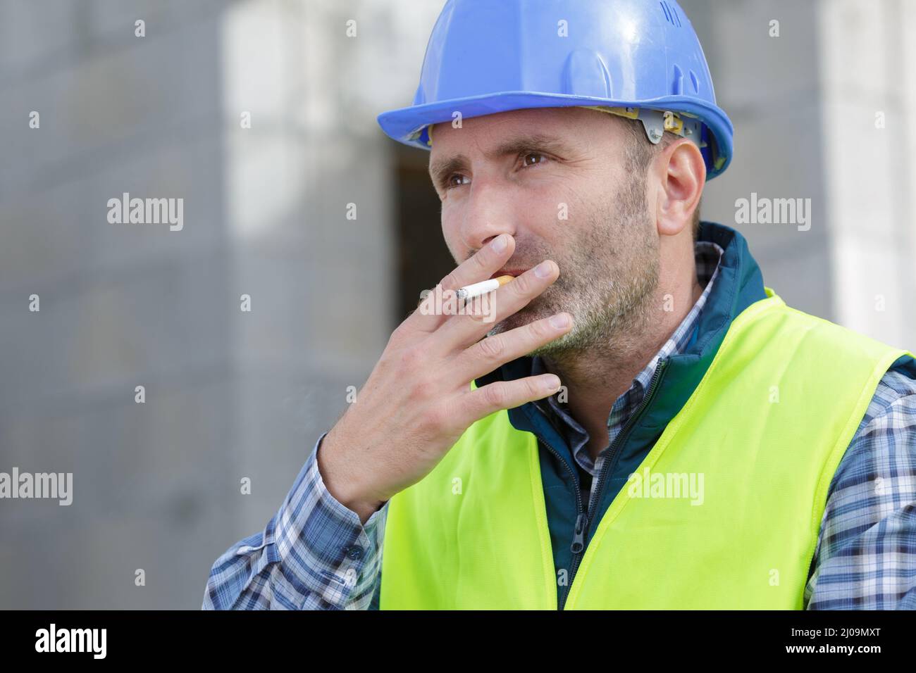 portrait of a worker smoking a cigarette Stock Photo - Alamy