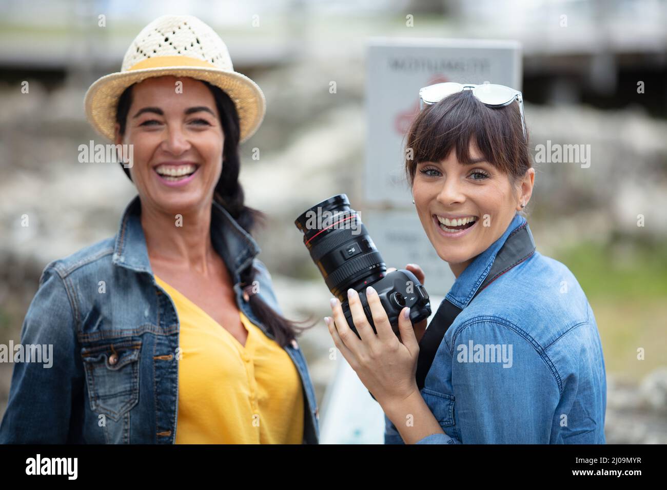 Two attractive women taking photos hi-res stock photography and images ...