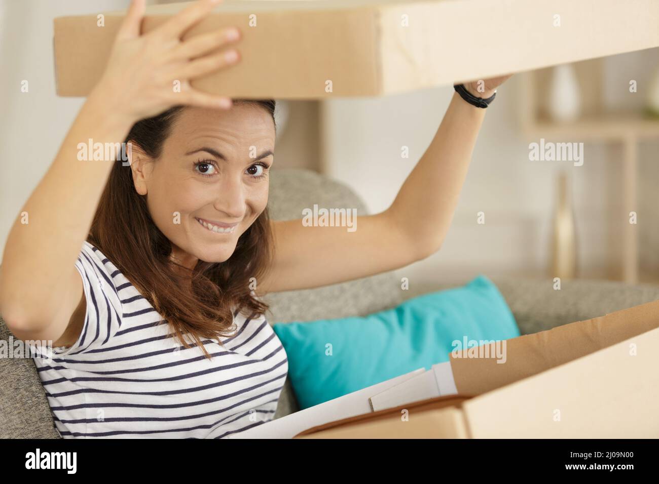 woman opening cardboard box Stock Photo - Alamy