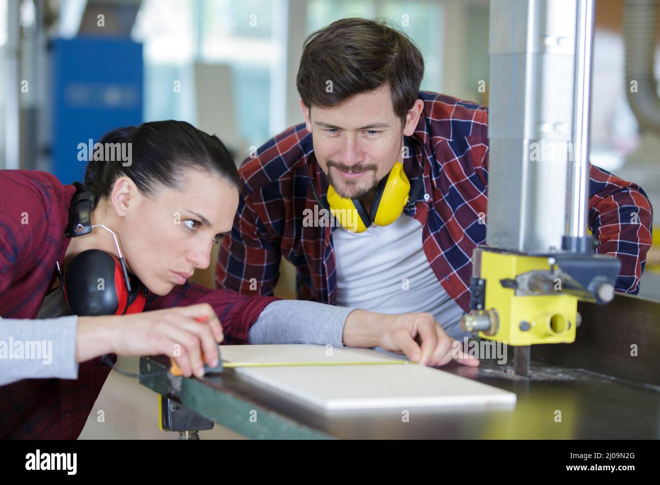 engineer training female apprentice on milling machine Stock Photo - Alamy