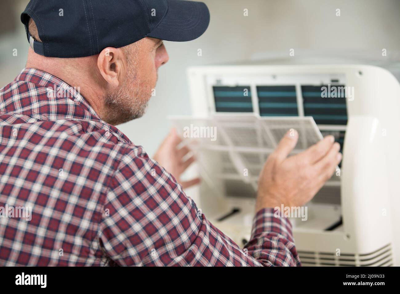 mature man repairing an air conditioning unit Stock Photo - Alamy