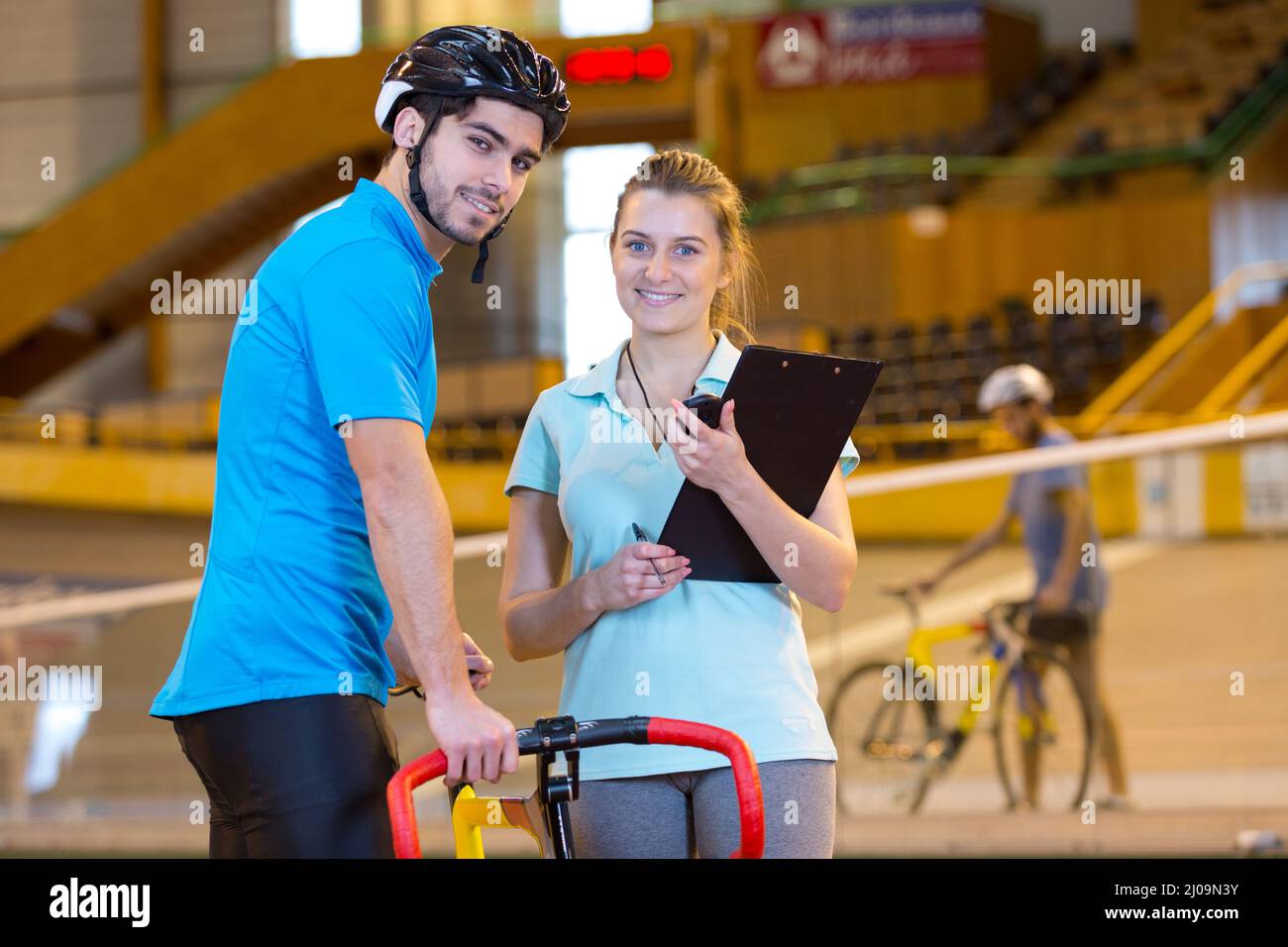 female coach with male cyclist Stock Photo - Alamy