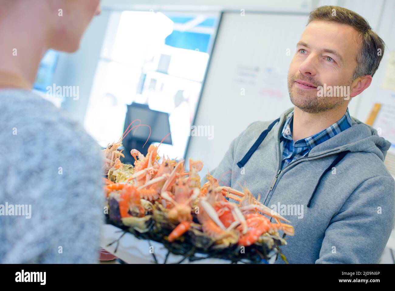 a fishmonger and a seafood platter Stock Photo - Alamy