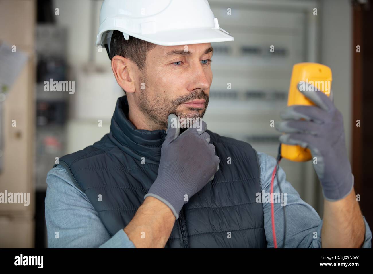 electrician using multimeter at work Stock Photo - Alamy