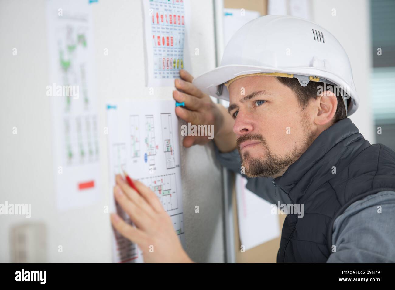 architect or engineer checking a new build house plan Stock Photo - Alamy