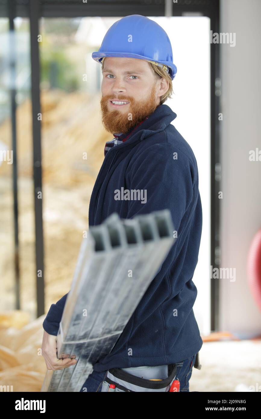 man carrys a metal frame Stock Photo - Alamy