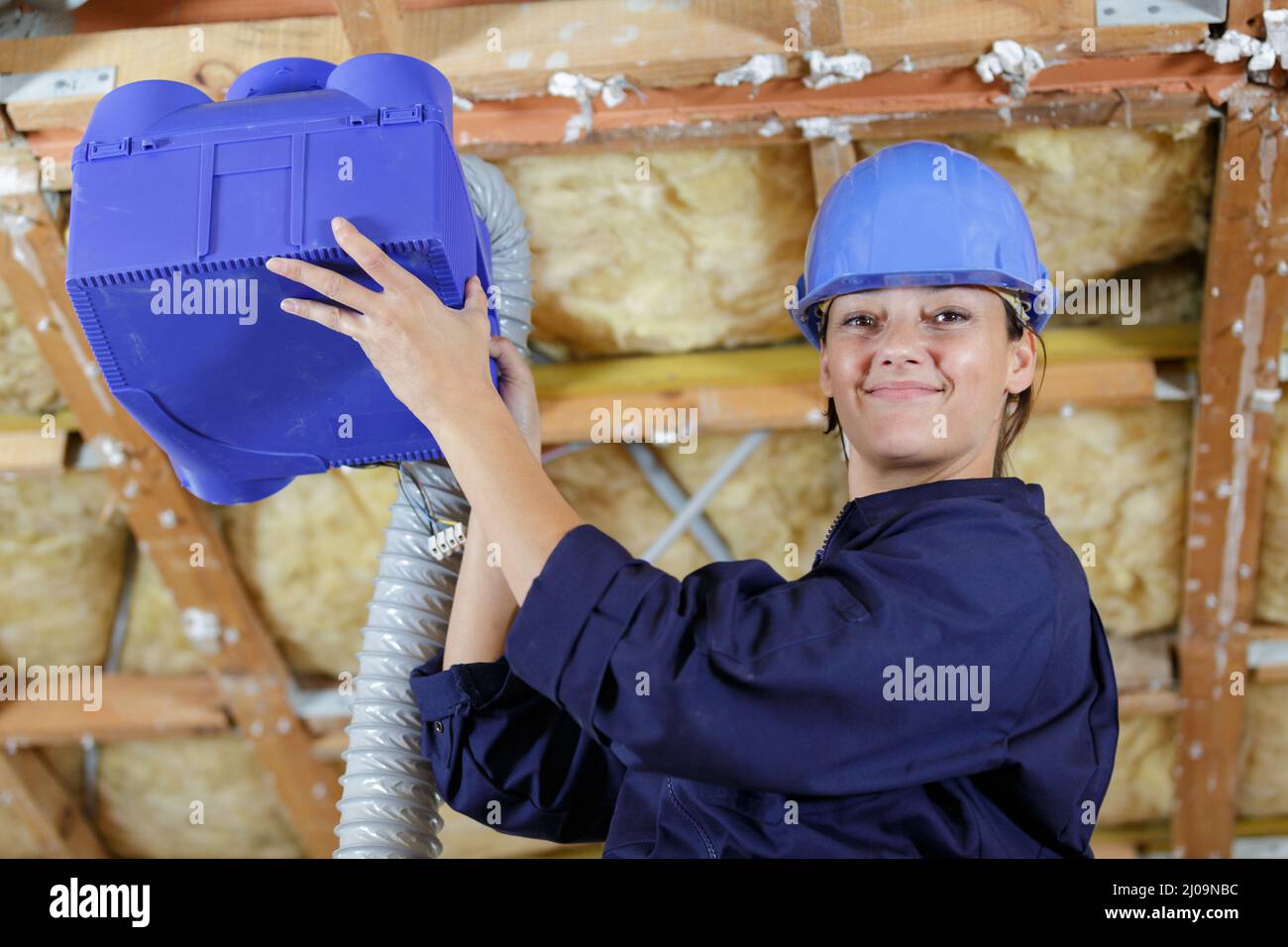 installing a blue ventilation box Stock Photo - Alamy
