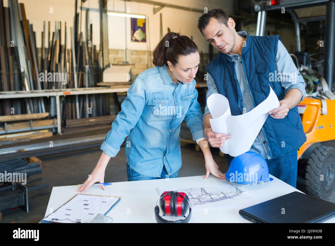 industrial workers looking at a plan Stock Photo - Alamy