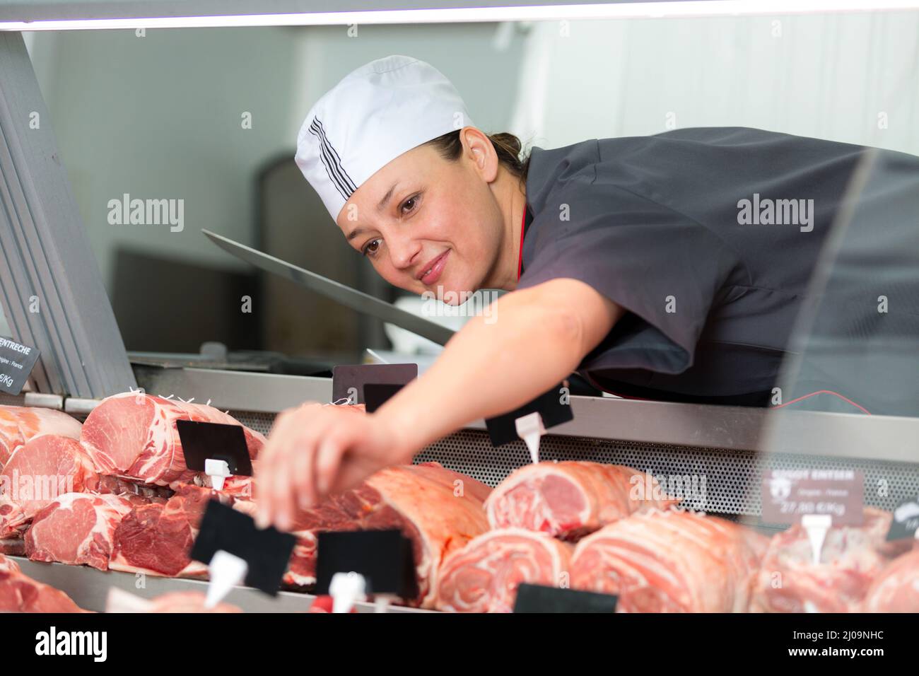 portrait of woman cutting meat Stock Photo - Alamy