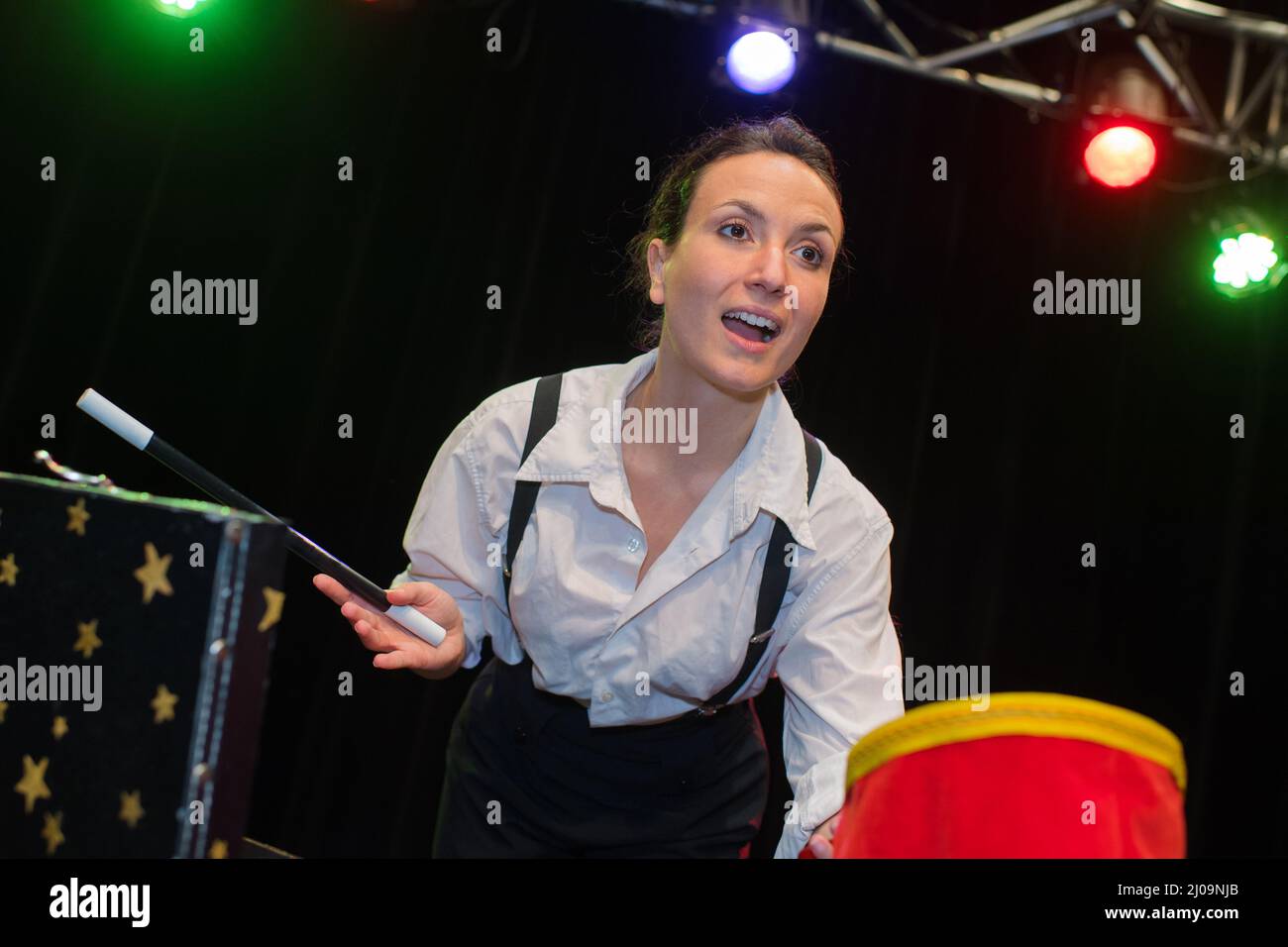 a woman magician on stage Stock Photo - Alamy