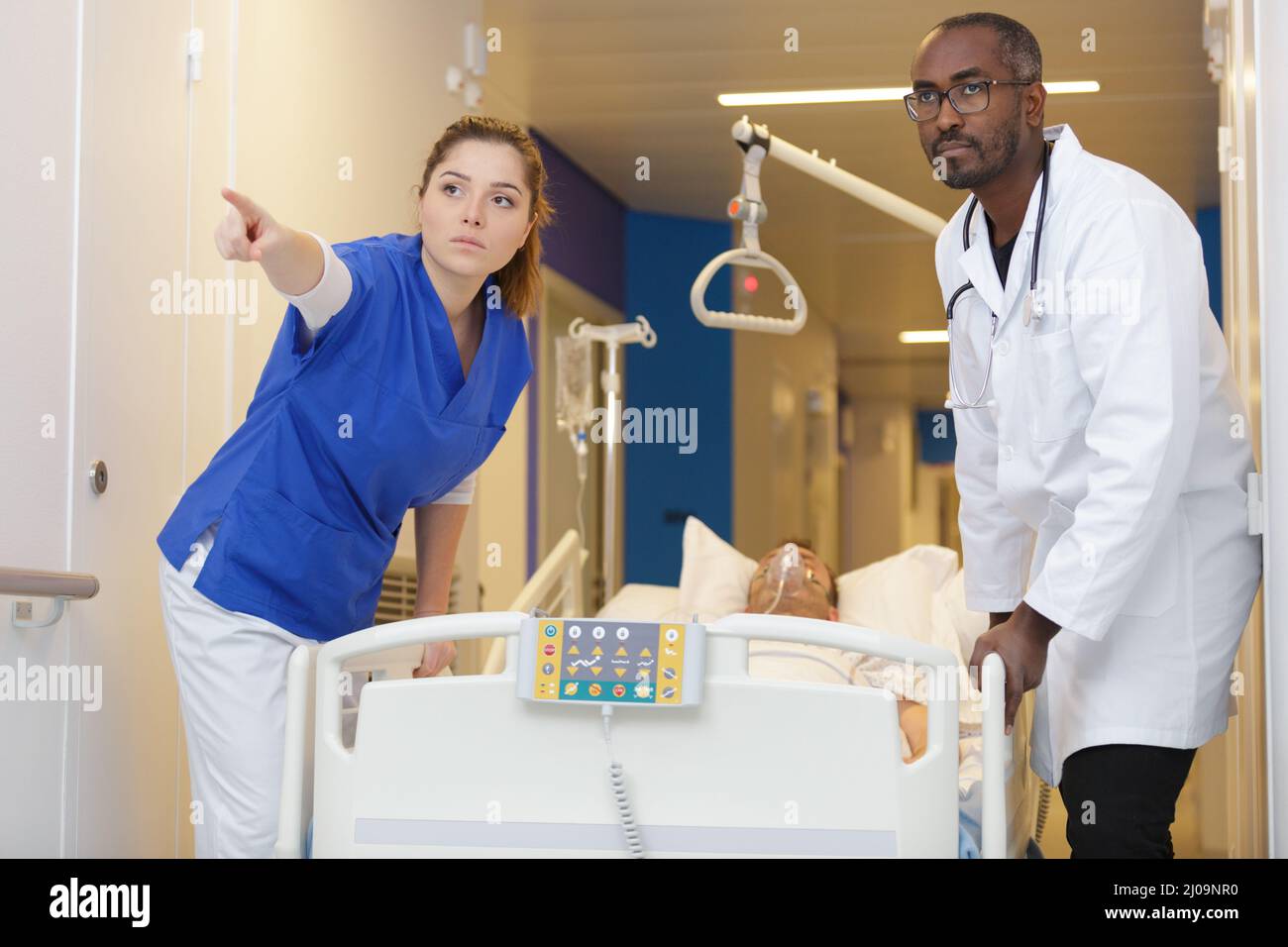 patient hospital bed moved by medical staff to operating room Stock ...
