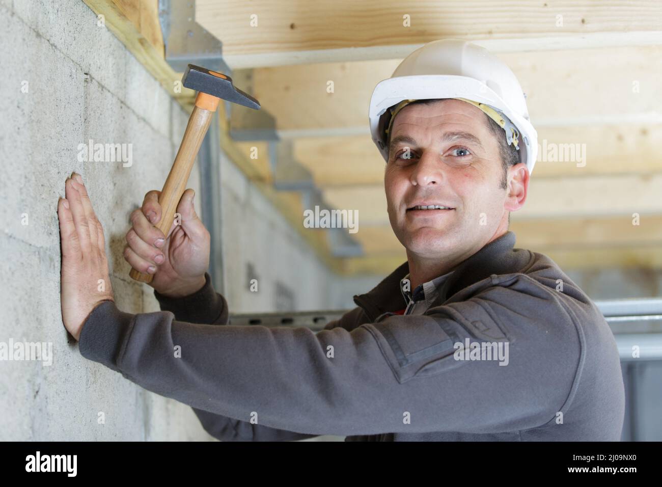 male construction worker using a hammer Stock Photo - Alamy