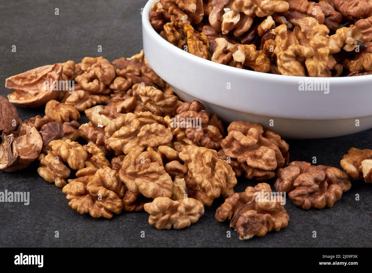 Pile of walnuts on a stone black surface Stock Photo - Alamy