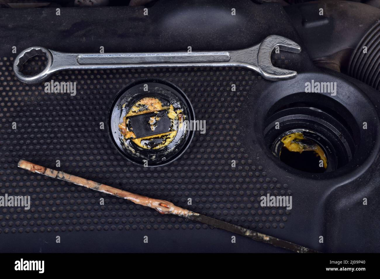 The thick, greasy yellow motor oil under oil cap as signs and symptom ...