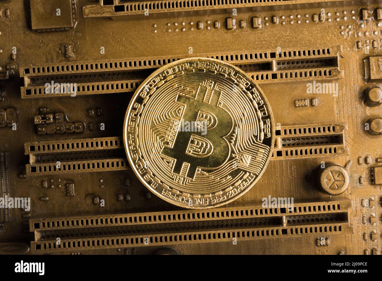 Gold coin bitcoin on the golden motherboard Stock Photo - Alamy