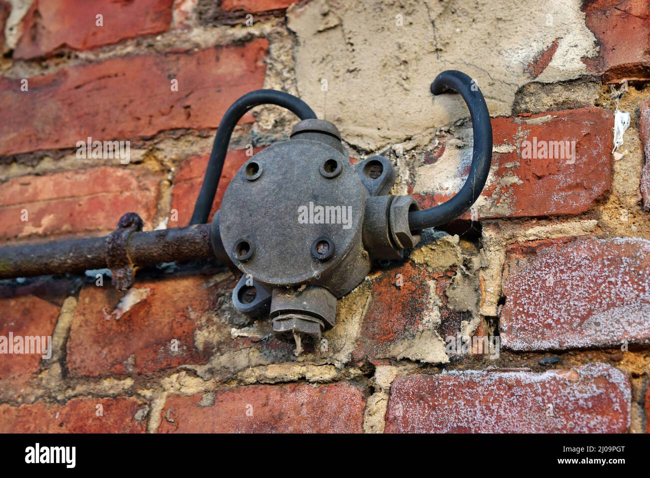 Old rusty metal electric box and black wires on the brick wall Stock ...