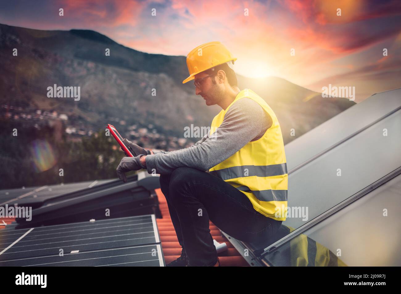 Man works on renewable energy system with solar panel for electricity ...