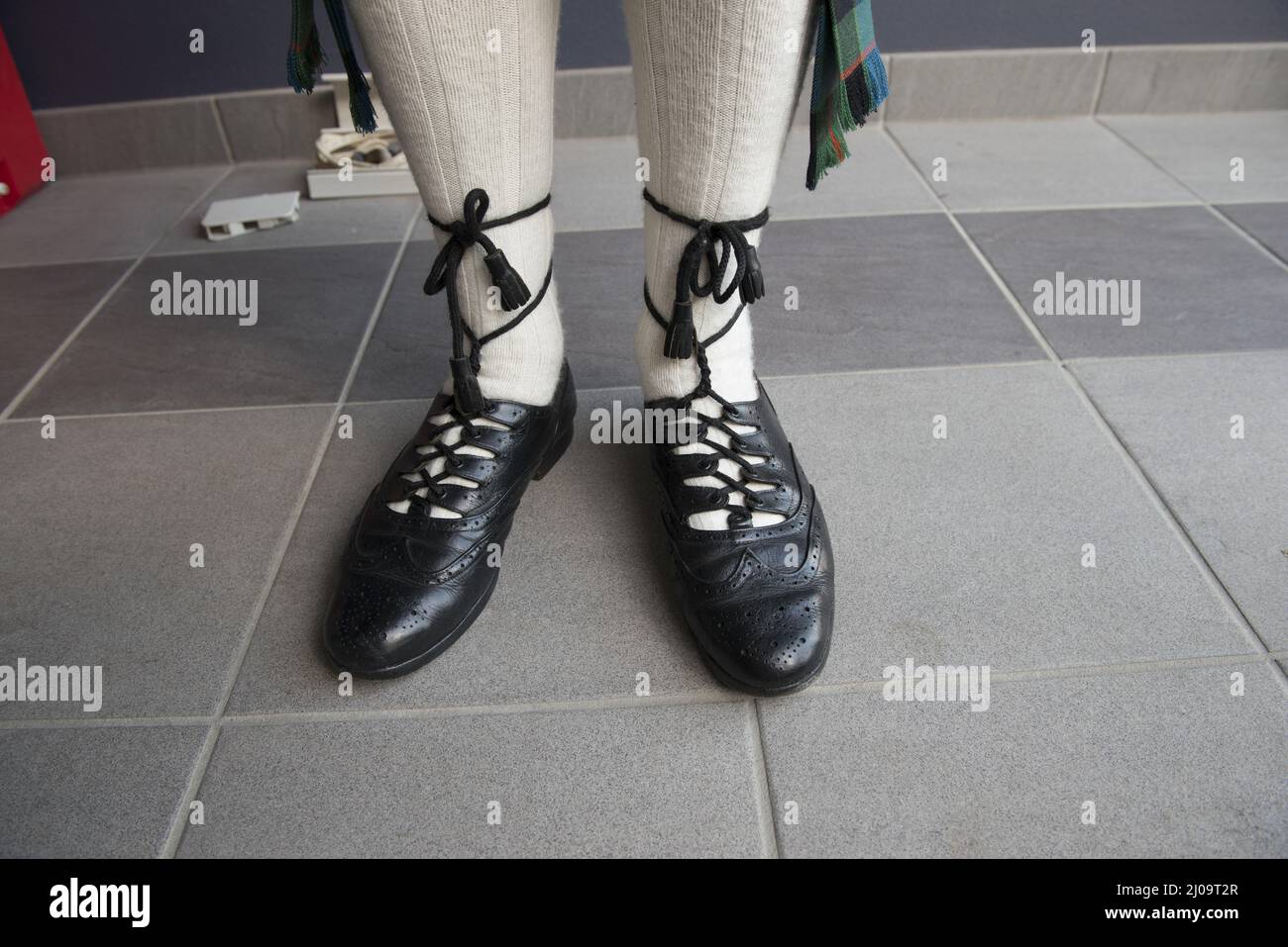 Closeup of a man's legs wearing white socks and traditional Scottish shoes Stock Photo - Alamy